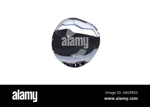 A crystal clear drop of water moves on an isolated white background ...
