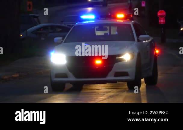 Montreal SPVM police car arriving at crime scene at dawn with flashing ...