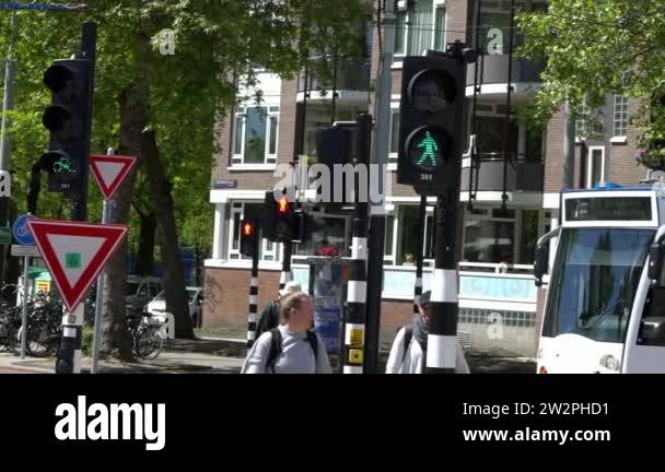 Amsterdam, Netherlands-13 May, 2019: Slow motion of European pedestrian crosswalk sign. Traffic ...
