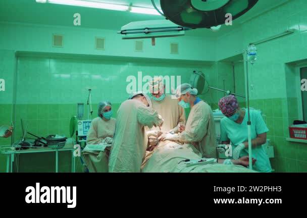 Male surgeons and assistants women during the operation in clinic ...