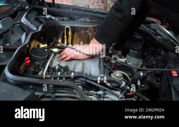 Repairing the car engine. A service station. The repairman inspects the ...