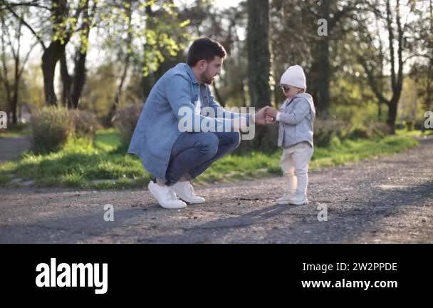 Adorable little gilr spend time with her father. Dad and daughter walk ...