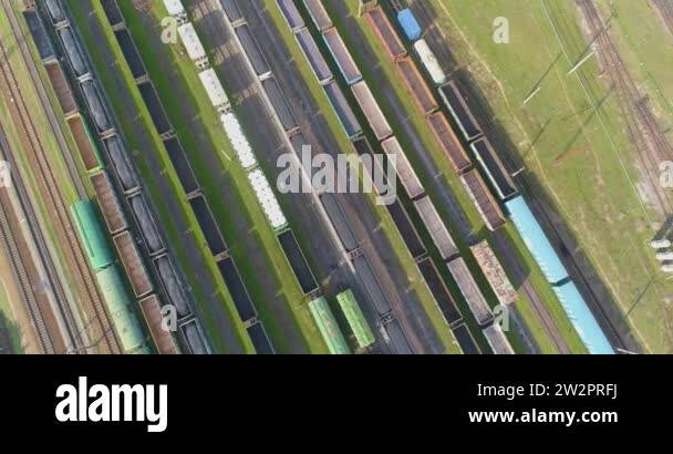 Large railway station frame with rotation. A freight train moves across ...