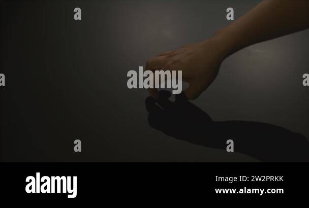 hand going into a pool of trying to grabbing it. Creating ripples in ...