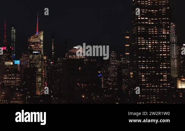 AERIAL: Breathtaking wide view the iconic Empire State Building disappearing behind residential ...