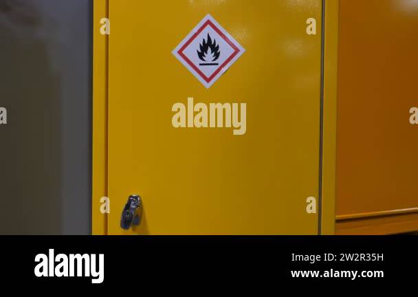 Man's hand opening yellow color metal box container with gas cylinder ...