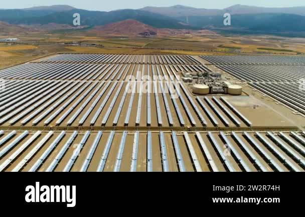 Aerial view of a farm of solar panels (solar cell) with its factory ...