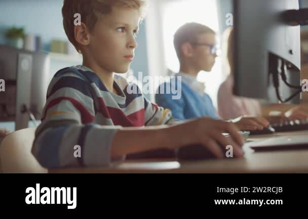 Elementary School Computer Science Classroom: Smart Little Boy Uses ...
