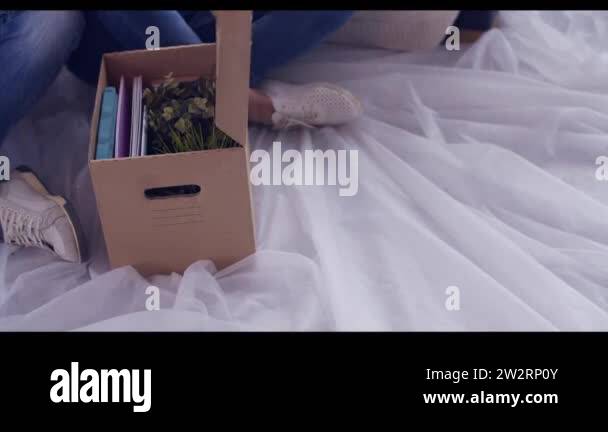 Excited Young Couple Unpacking Things Opening Box And Talking During