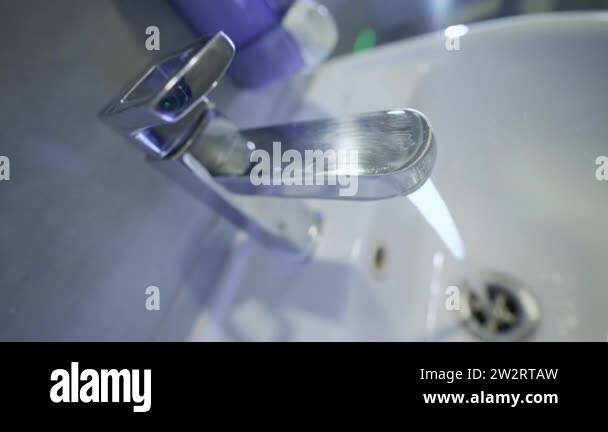 Steam from hot water in the sink. Hot tap water. Warm water flows from ...