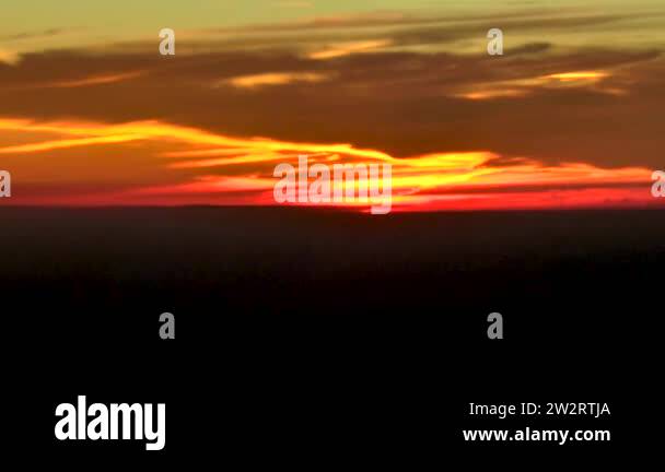 Sunset captured from an airplane in flight at high altitude. Camera ...
