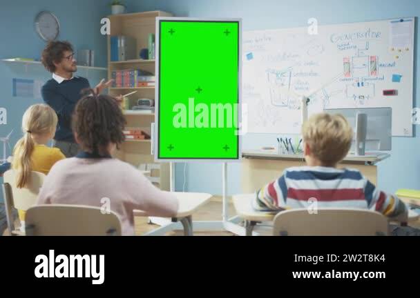 In the Elementary School Classroom: Teacher Uses Vertical Green Mock-up ...