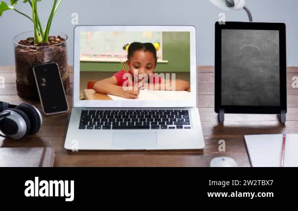 Animation of laptop showing mixed race girl writing in notebook on ...