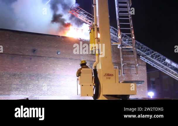 Fireman watching fire burn on a building Stock Video Footage - Alamy