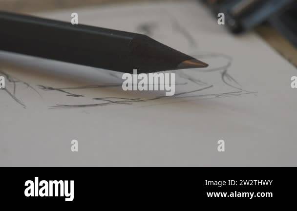 Macro view. Graphite Pencil lies on sheet of white paper on which ...