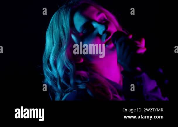 Live vocal performance of singer in darkness, vocalist cute girl in ...