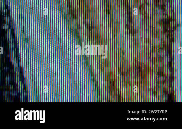 Pixels in the working old analog TV screen close up. Red, blue and ...