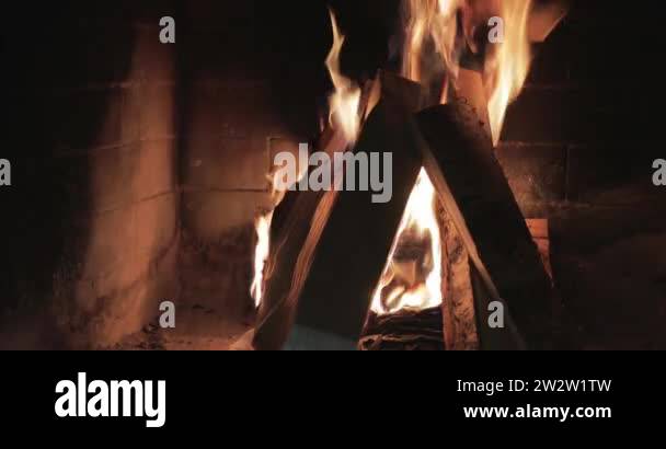 The big fire with firewood in a fireplace, bonfire burning, Brick walls ...