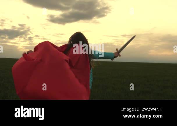 children fight with a toy sword. happy childhood concept. free girl in ...