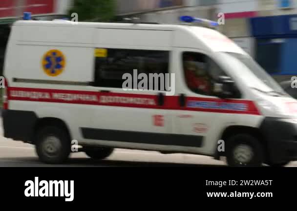 Ambulance white medical van with loud siren and blue flashing lights on ...