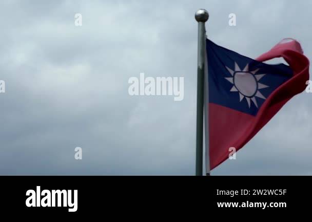 Slow motion taiwanese flag waving in the wind on flagpole at an Taipei ...
