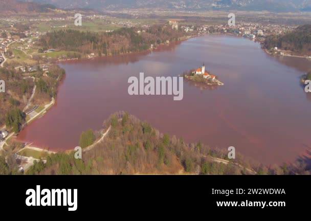 DRONE: Flying above the famous lake Bled in Slovenia surrounded by red ...