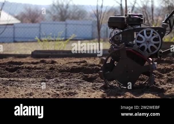 Man working in the garden with Garden Tiller. Garden tiller to work ...