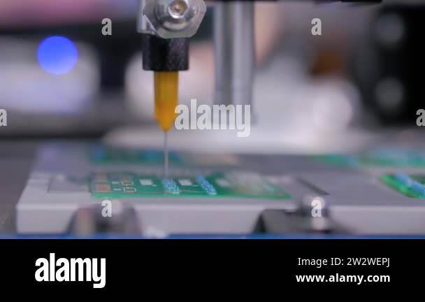 Automatic manipulator with dispenser needle dispensing solder paste on ...