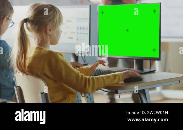 Elementary School Computer Science Classroom: Cute Little Girl Uses ...