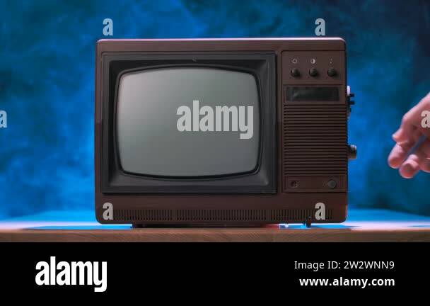 Man tries to turn on the old TV, knocks on it, scattering dust ...