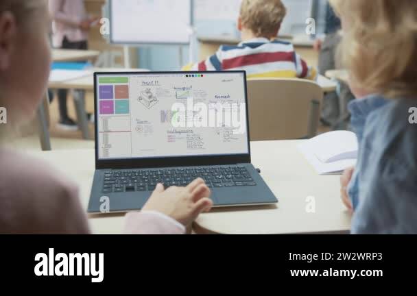 Elementary School Science Class: Over the Shoulder Two Little Kids Use ...