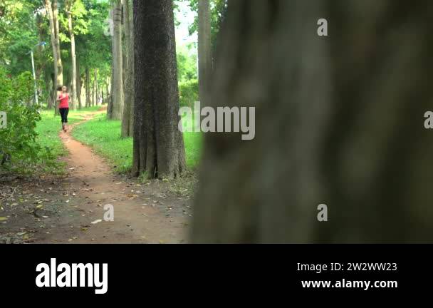 4K Runner running woman jogging in Taipei city Daan park. Exercising ...