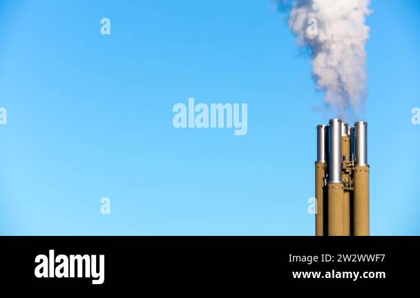 White smoke rising from smokestacks into the blue sky. Conceptual video ...