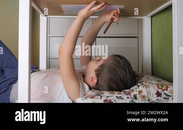 Boy painting upside down. Stayathome. Leisure activity at home, indoor. Preschooler drawing ...