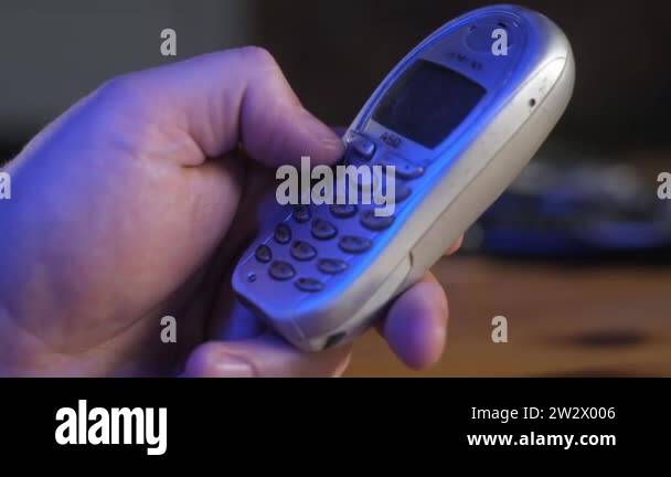 Close-up of man's hand typing phone number with fingers on keyboard of ...