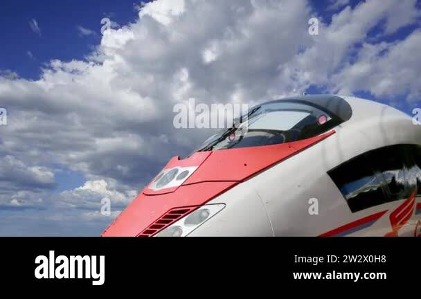 Aeroexpress Train Sapsan against the moving clouds-- high-speed train ...