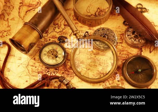 Vintage magnifying glass, compass, telescope and a pocket watch lying ...
