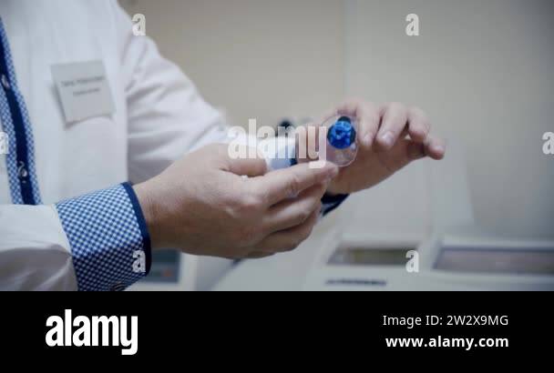 Making glasses, Close up. The ophthalmologist holds the finished lens ...