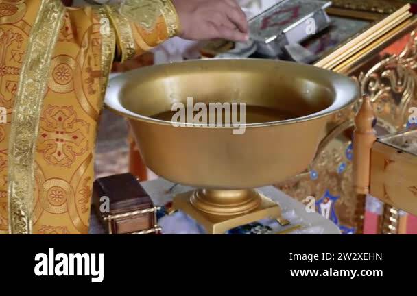 Consecration of water. The priest blesses the water at baptism. Baptismal font for a child Stock ...
