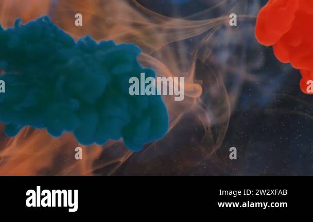 Bright blue and red inks injecting from syringes under water Stock ...