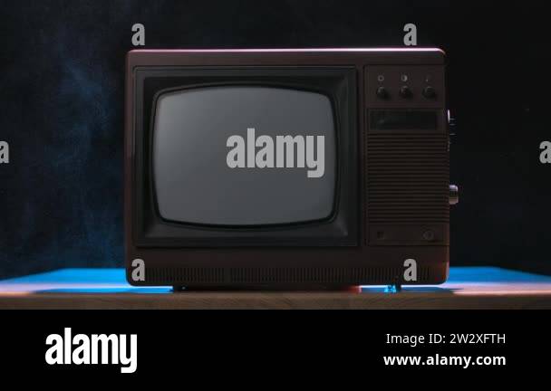 Man turns on an old retro TV and blows off the dust. Vintage television ...