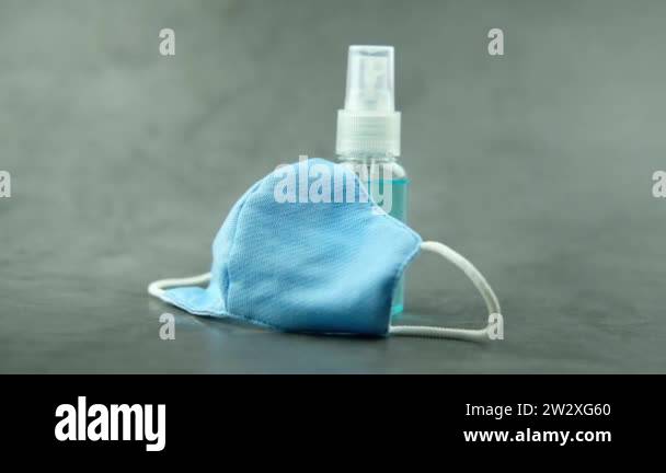 Applying alcohol spray from the plastic bottle to prevent the spread of ...