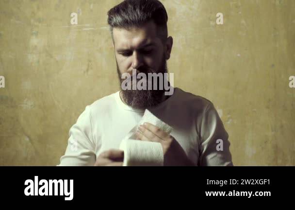 Man holds toilet paper roll. WC, restroom, Hygiene, sanitary, Man face ...