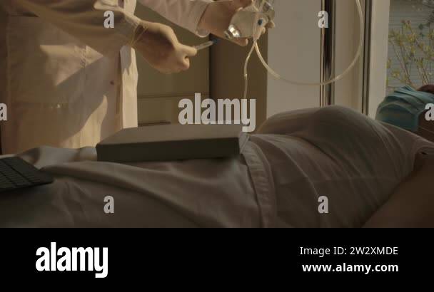 Unrecognizable doctor mixing drugs for dropper in hospital ward and ...