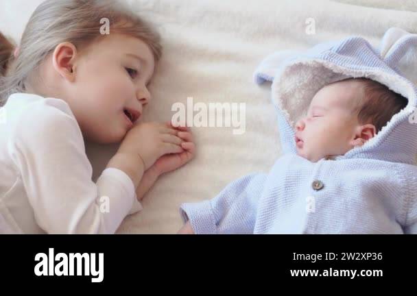Childhood, infancy, family, sleep, rest concept - close up of two ...