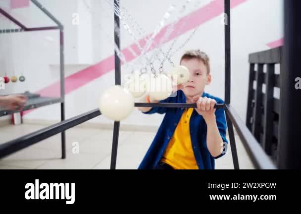 Two brothers are experimenting with Newton's pendulum. The concept of ...