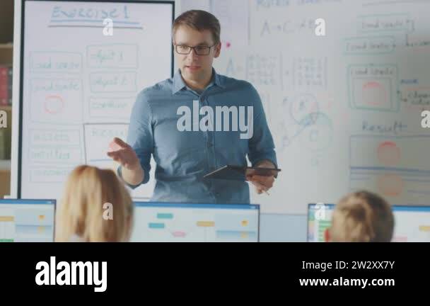 Elementary School Class: Teacher Uses Interactive Digital Whiteboard, Explains Lesson to Diverse ...