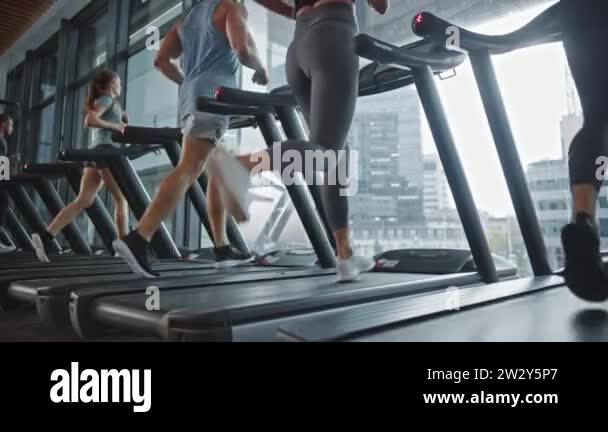 Fit Athletic Woman Walks onto Treadmill and Starts Running, Doing Her ...