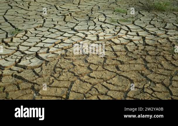 Drought cracked lake pond wetland clay drying up the soil crust earth ...