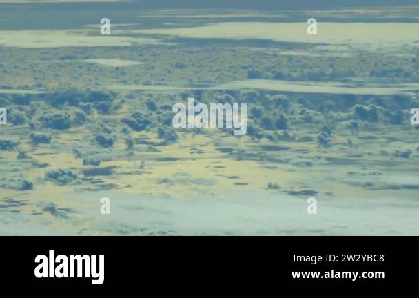 Flying above the clouds. Actual over-the-ocean, high altitude airplane ...